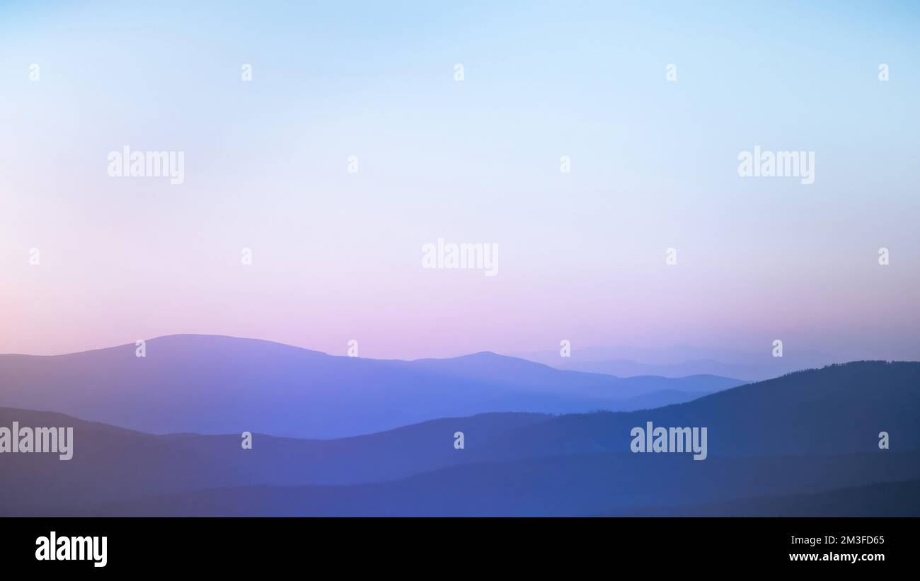 The layers of dreamy silhouette of the mountain range between sunset ...