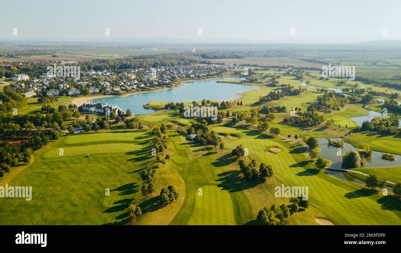 A drone view of water bodies surrounded by greenery and buildings in ...