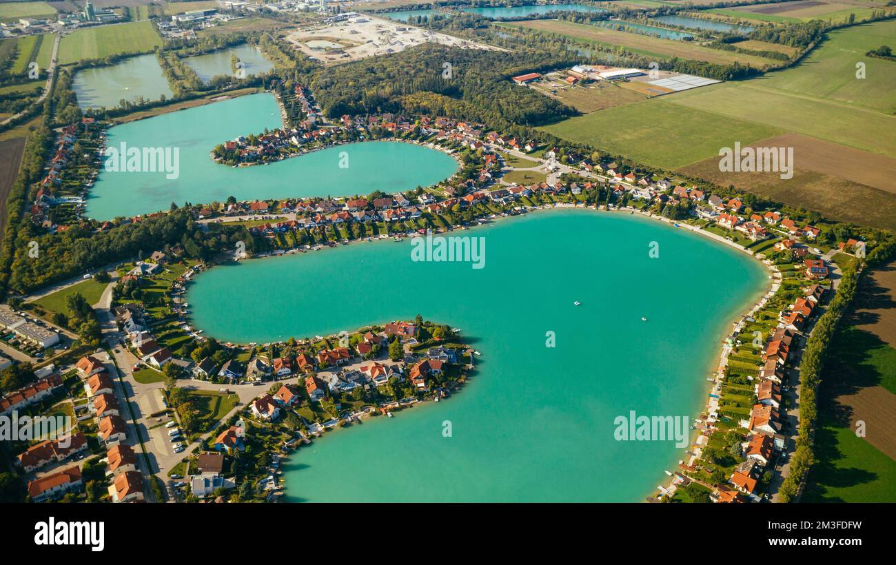 A drone view of water bodies surrounded by greenery and buildings in ...