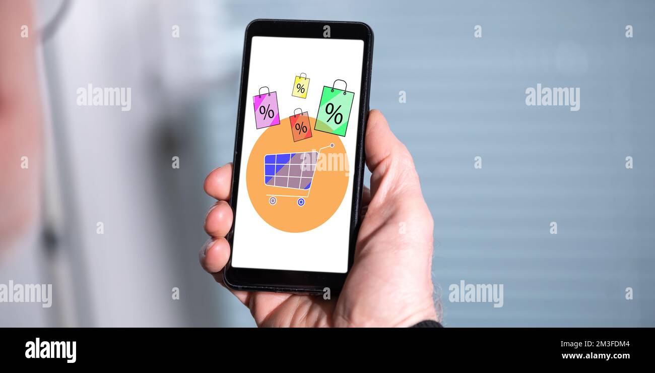 Hand holding a smartphone with discount concept Stock Photo - Alamy