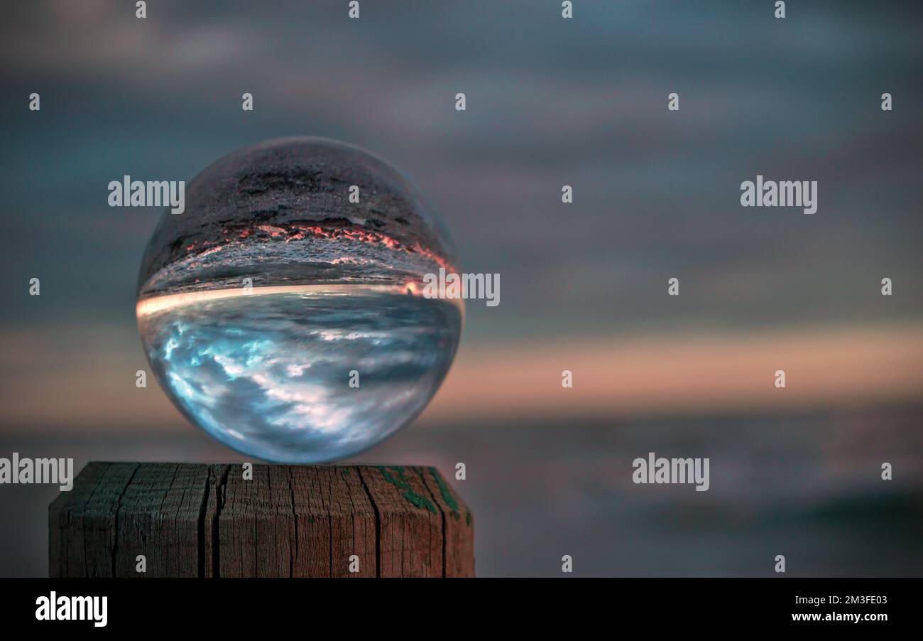 transparent lens ball in a sea ocean landscape background. trasparent ...