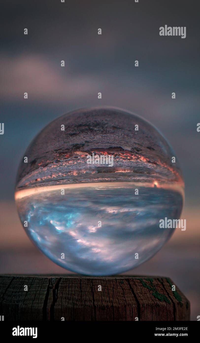 transparent lens ball in a sea ocean landscape background. trasparent ...