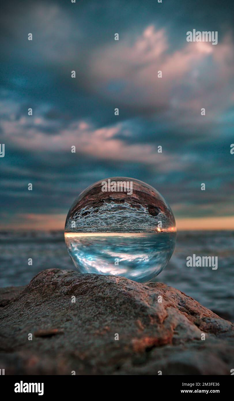 transparent lens ball in a sea ocean landscape background. trasparent ...