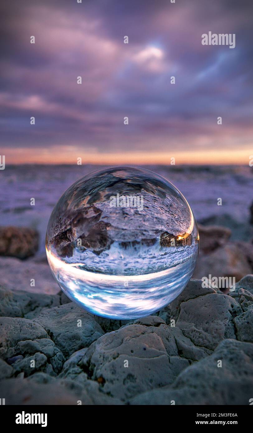 transparent lens ball in a sea ocean landscape background. trasparent ...