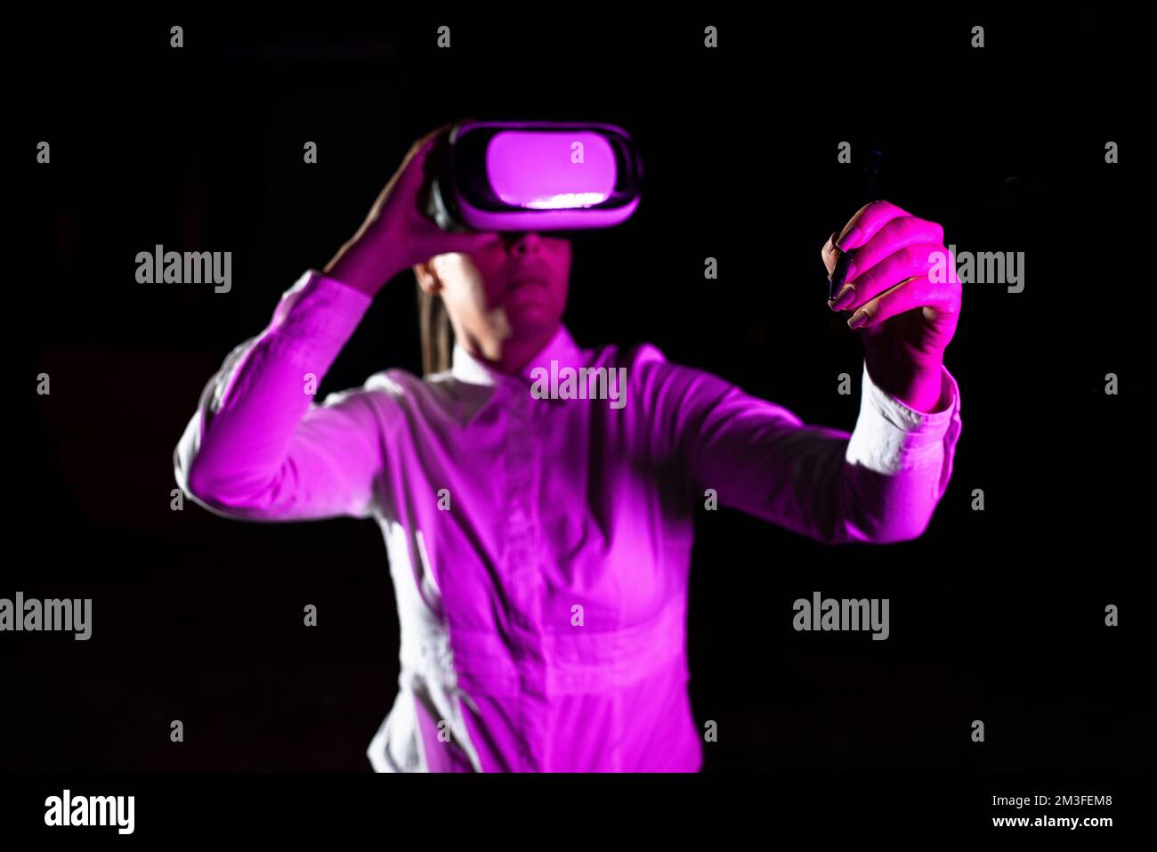 Female Manager Wearing Virtual Reality Headset Holding Pet While ...