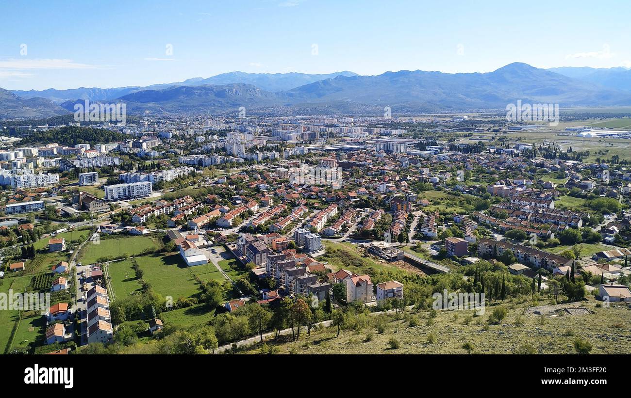 An aerial view of Podgorica cityscape with lush green vegetation in ...