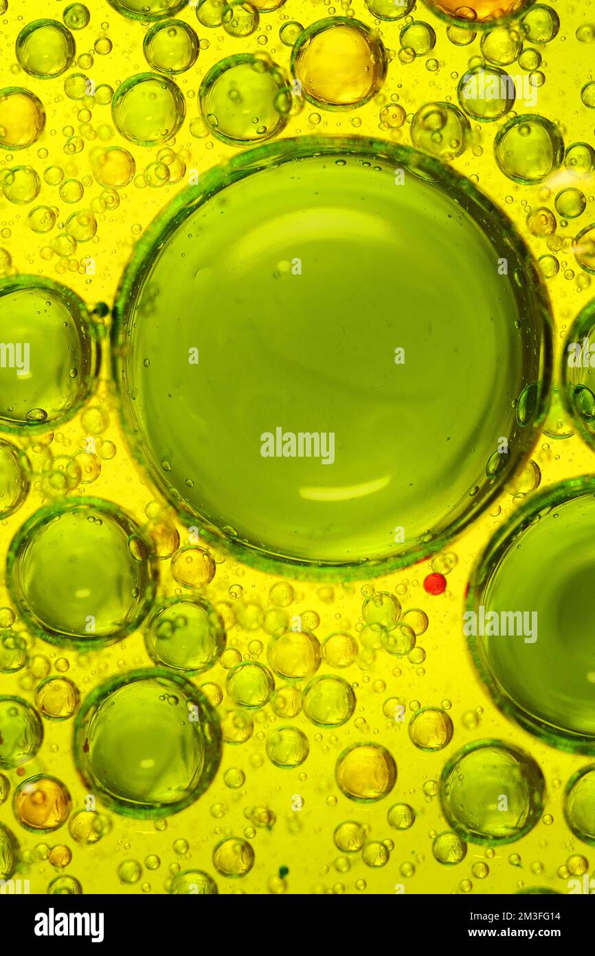 oil and water blisters on colored background Stock Photo - Alamy