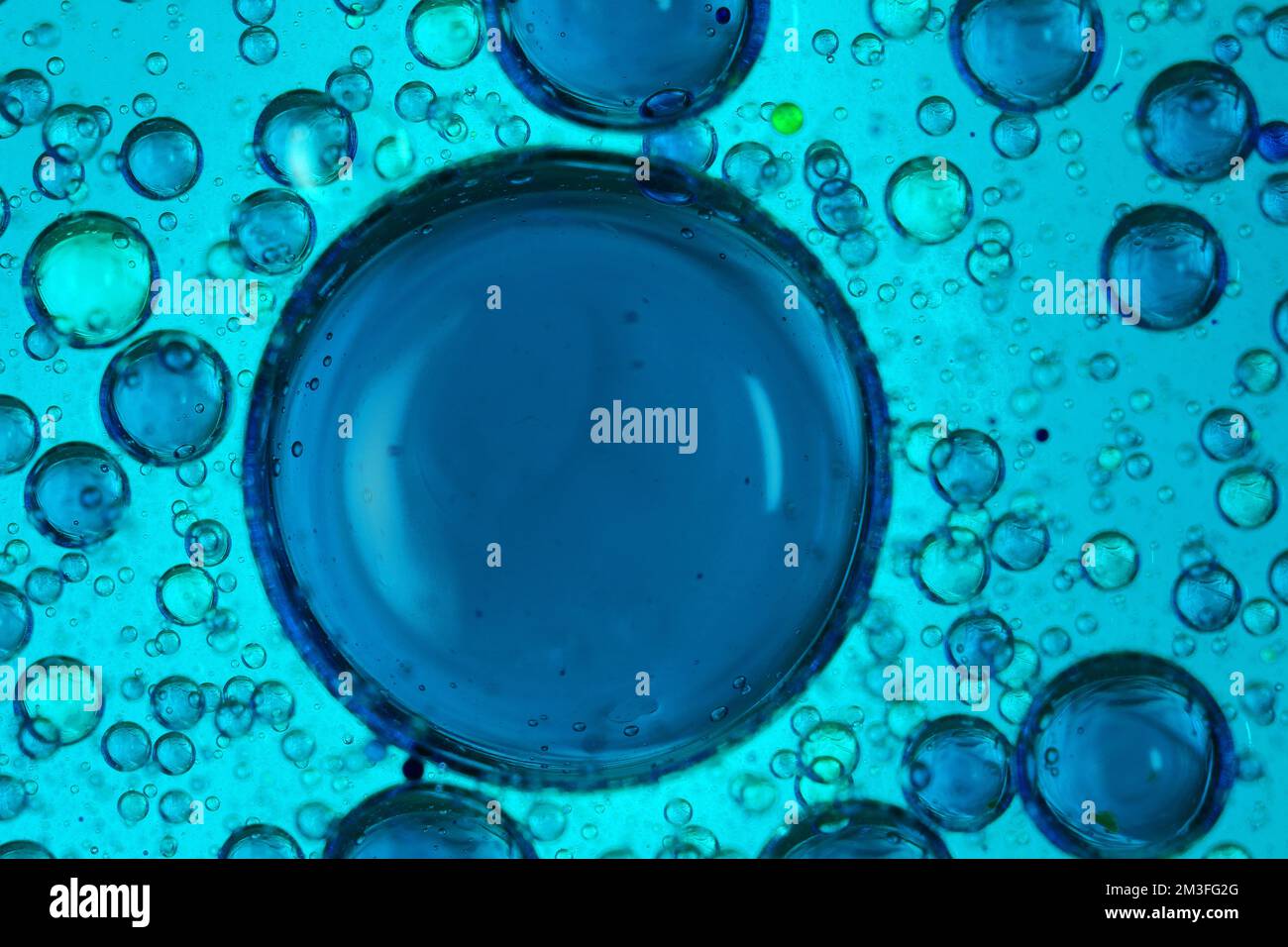 oil and water blisters on colored background Stock Photo - Alamy