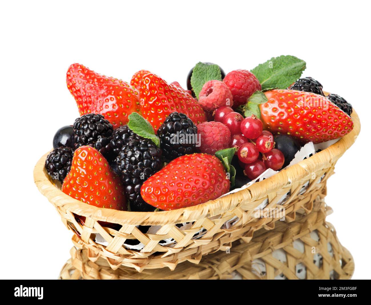 Mixed berry fruits in a wicker basket Stock Photo - Alamy