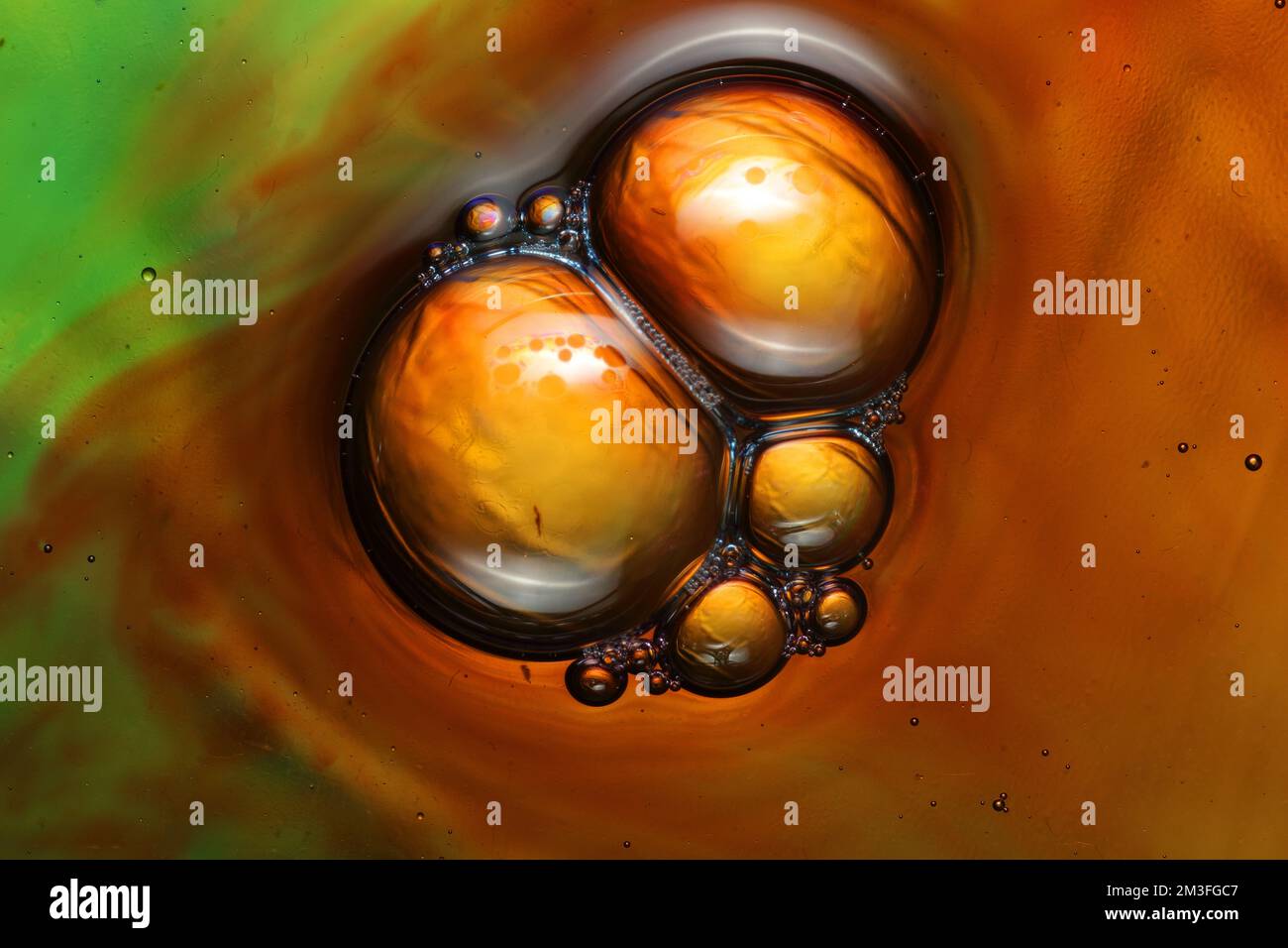 oil bubbles with water on glass and golden background Stock Photo - Alamy