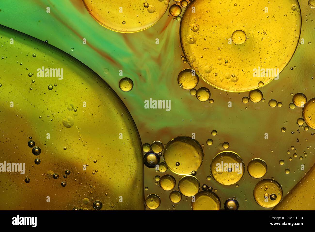 oil bubbles with water on glass and golden background Stock Photo - Alamy
