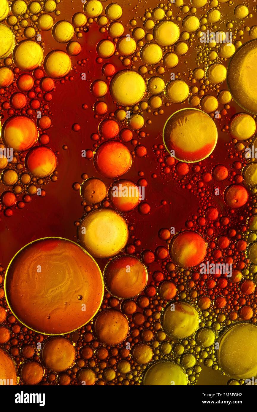oil bubbles with water on glass and golden background Stock Photo - Alamy