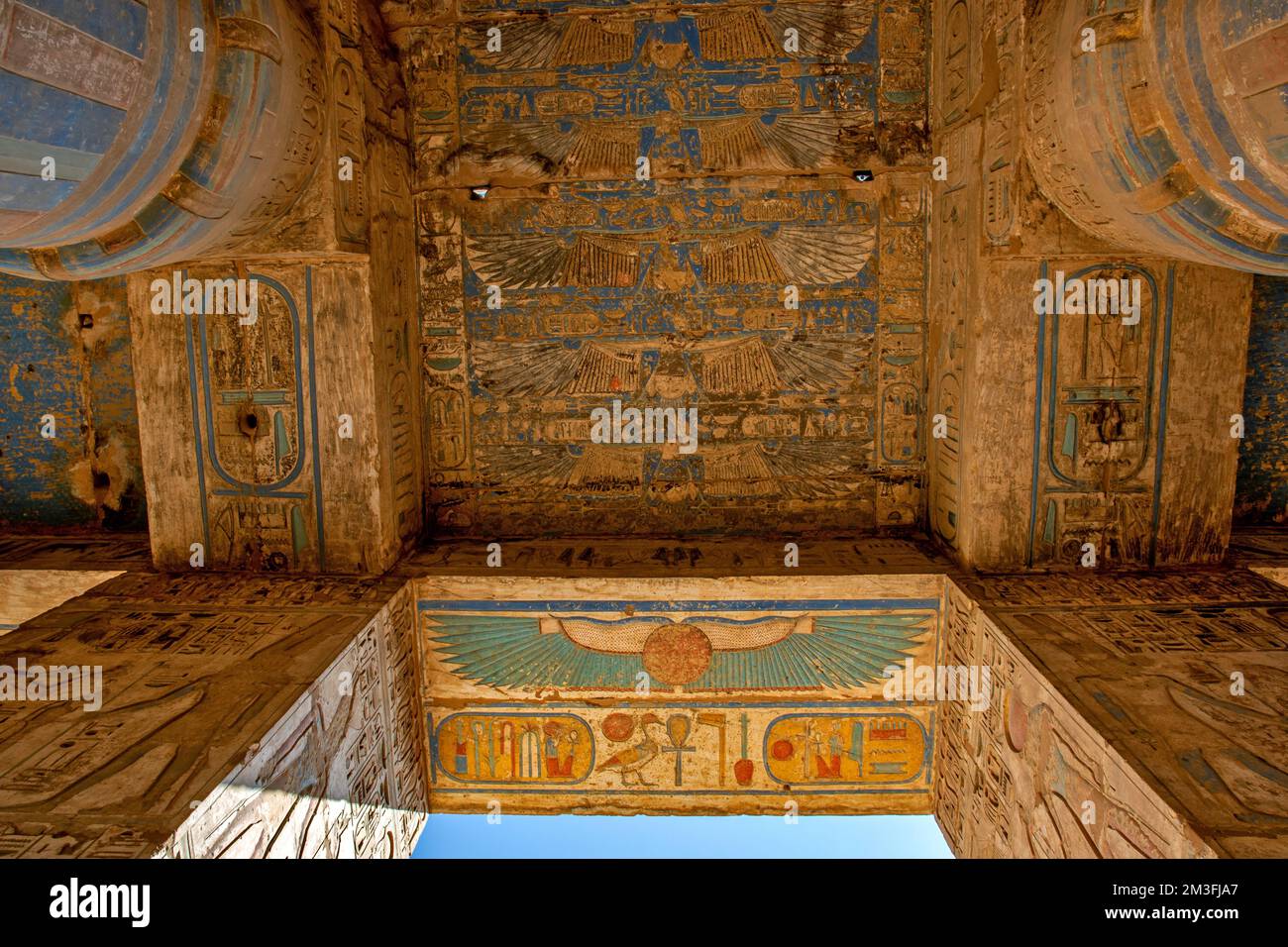 The interior of an Egyptian temple ceiling with colorful paintings and ...