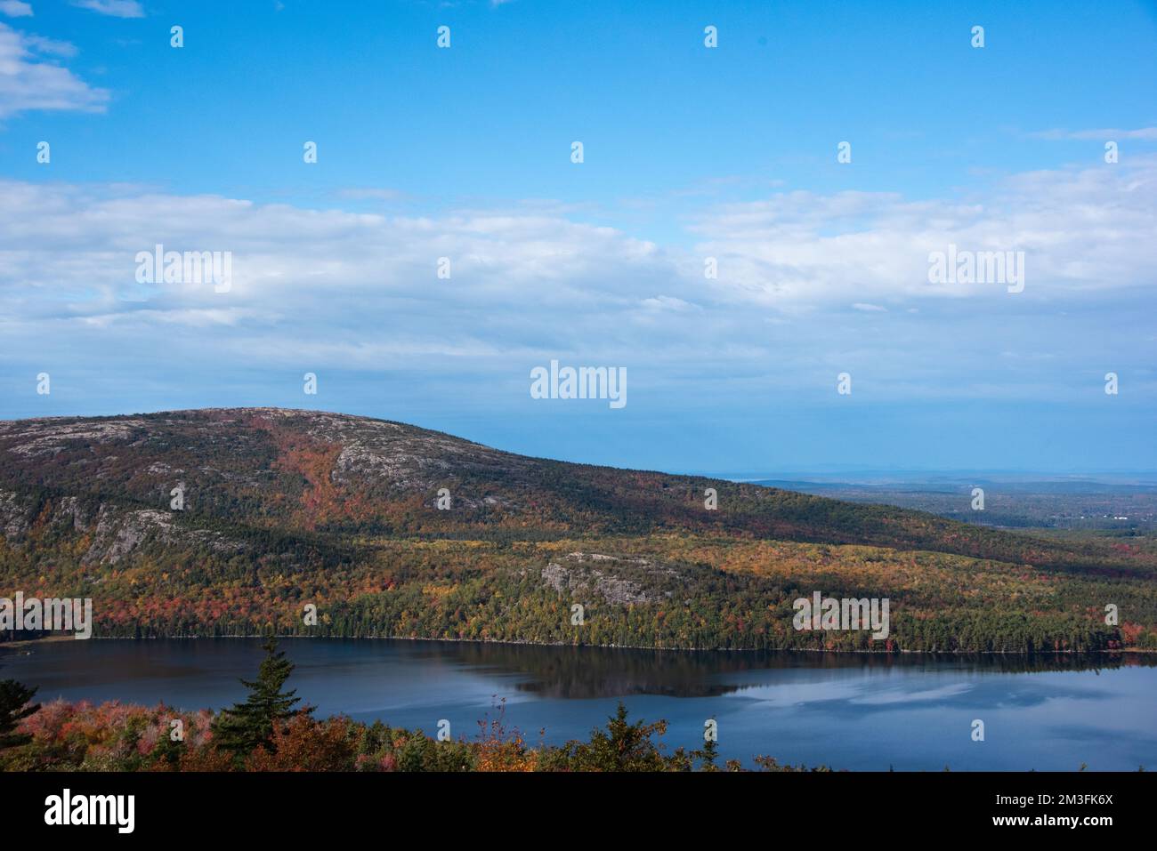The beautiful view of the lake and hillside covered with autumn trees ...