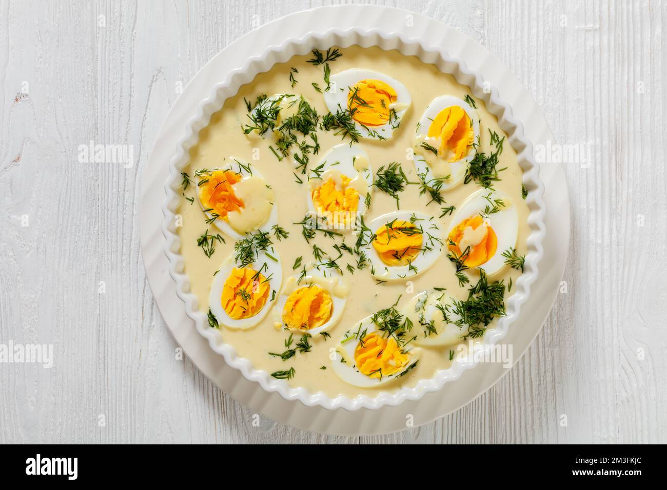 Senfeier, hard boiled eggs in rich creamy mustard sauce in white baking ...