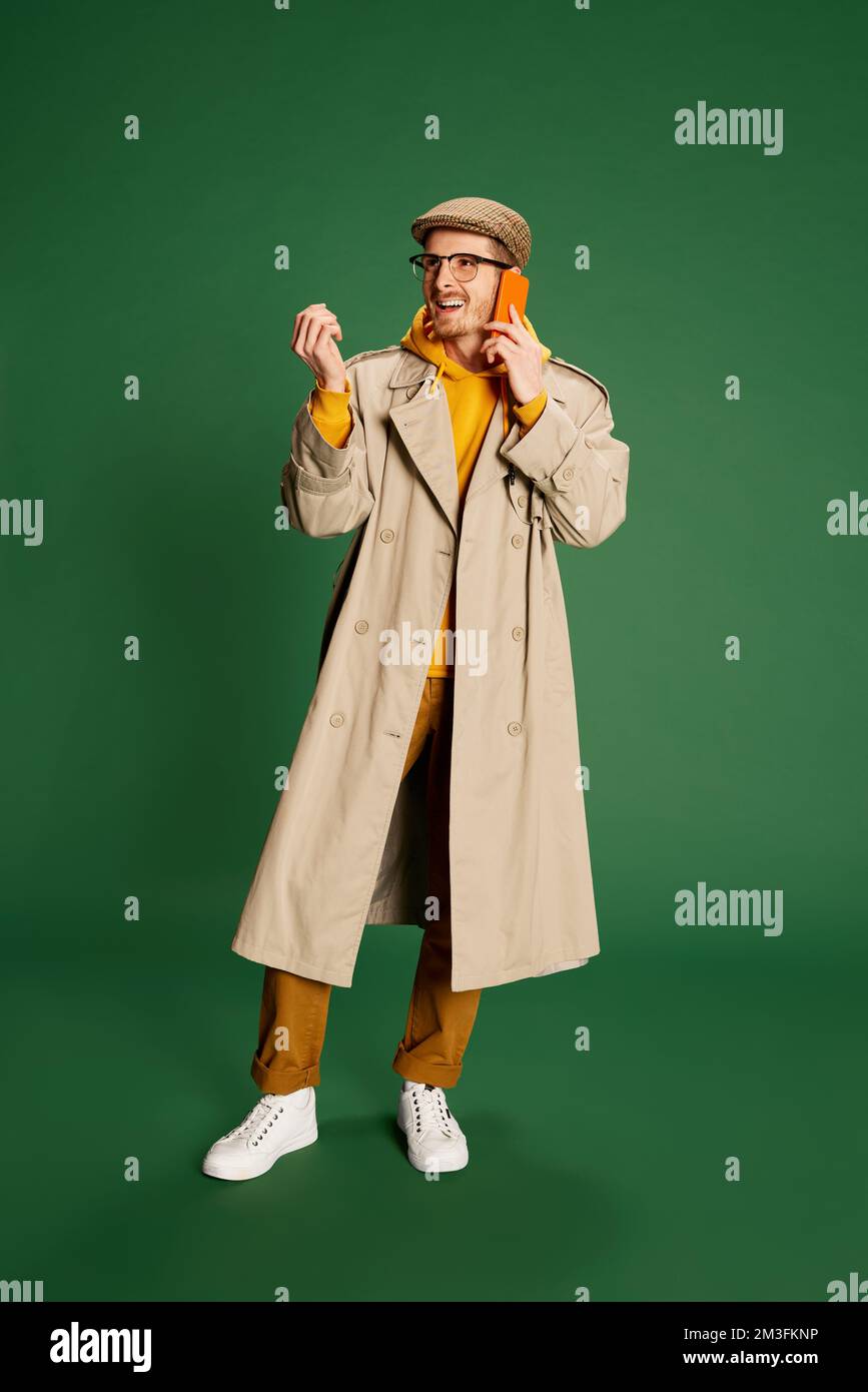 Portrait of young stylish man in trendy autumn clothes posing, talking ...