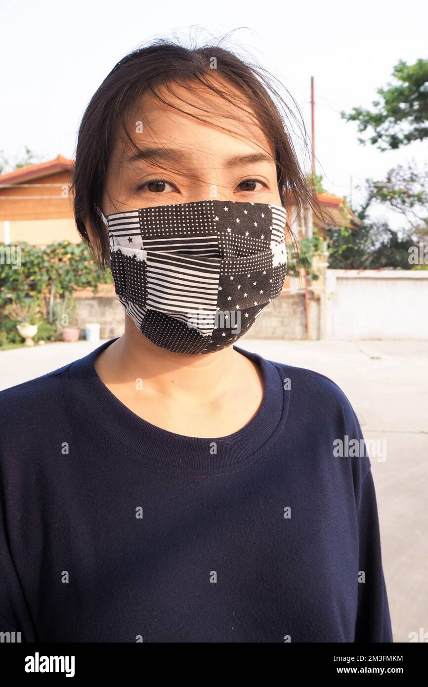 Woman wearing a black mask and expressing feelings Stock Photo - Alamy