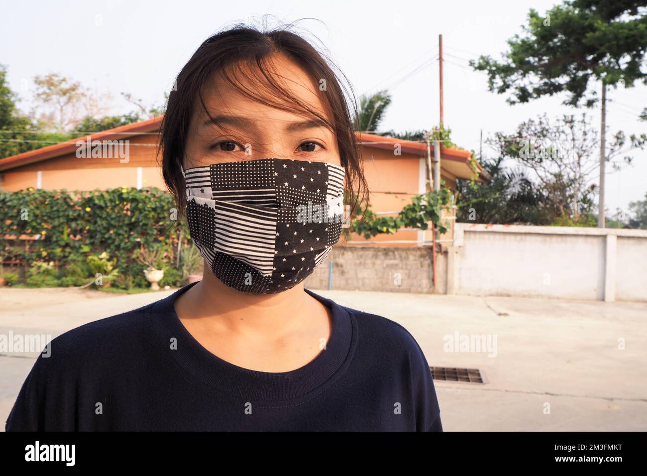 Woman wearing a black mask and expressing feelings Stock Photo - Alamy