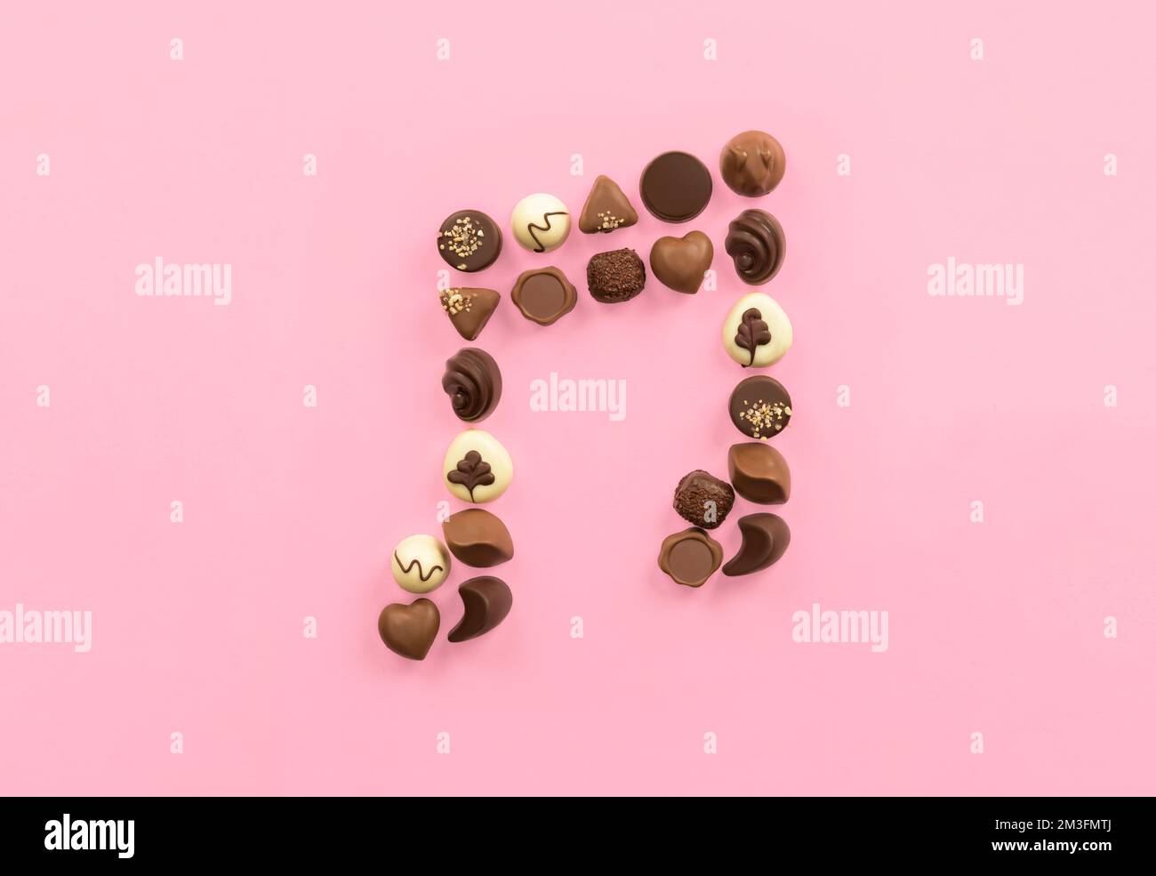 musical notes made of chocolates on a pink background Stock Photo - Alamy