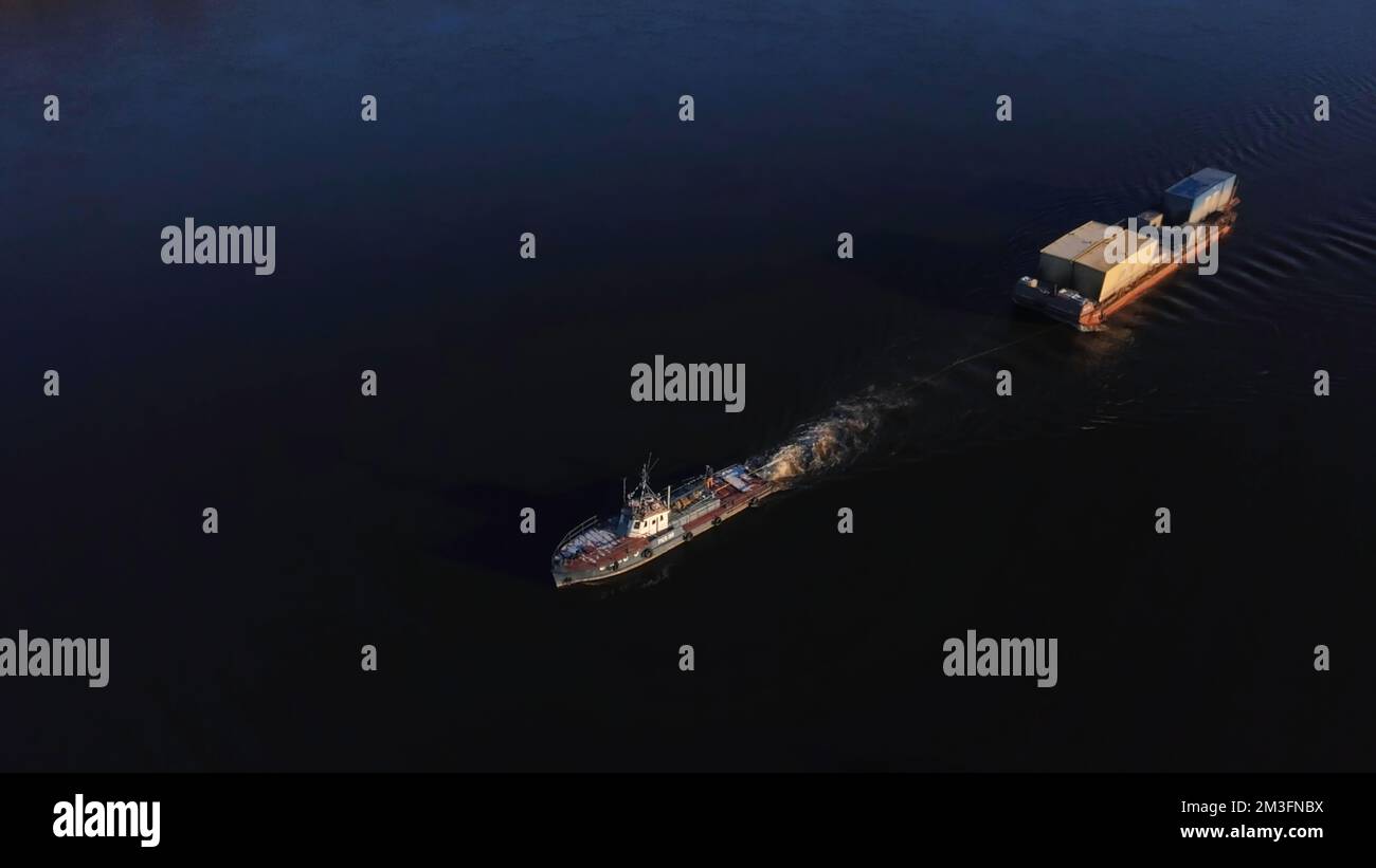 Aerial view of shipping barge transporting goods up the river. Clip ...