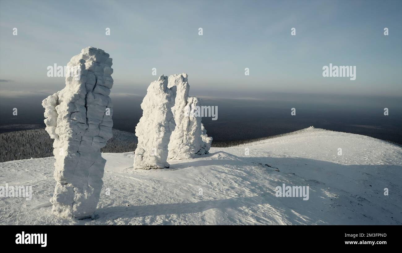 Aerial view of breathtaking snow covered stone formations on a blue ...