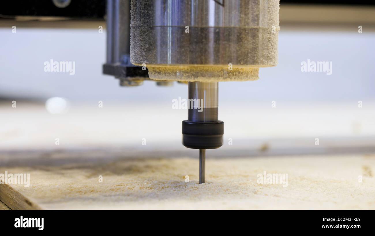 Milling machine with CNC cutting the wooden workpiece. Media. Close up ...