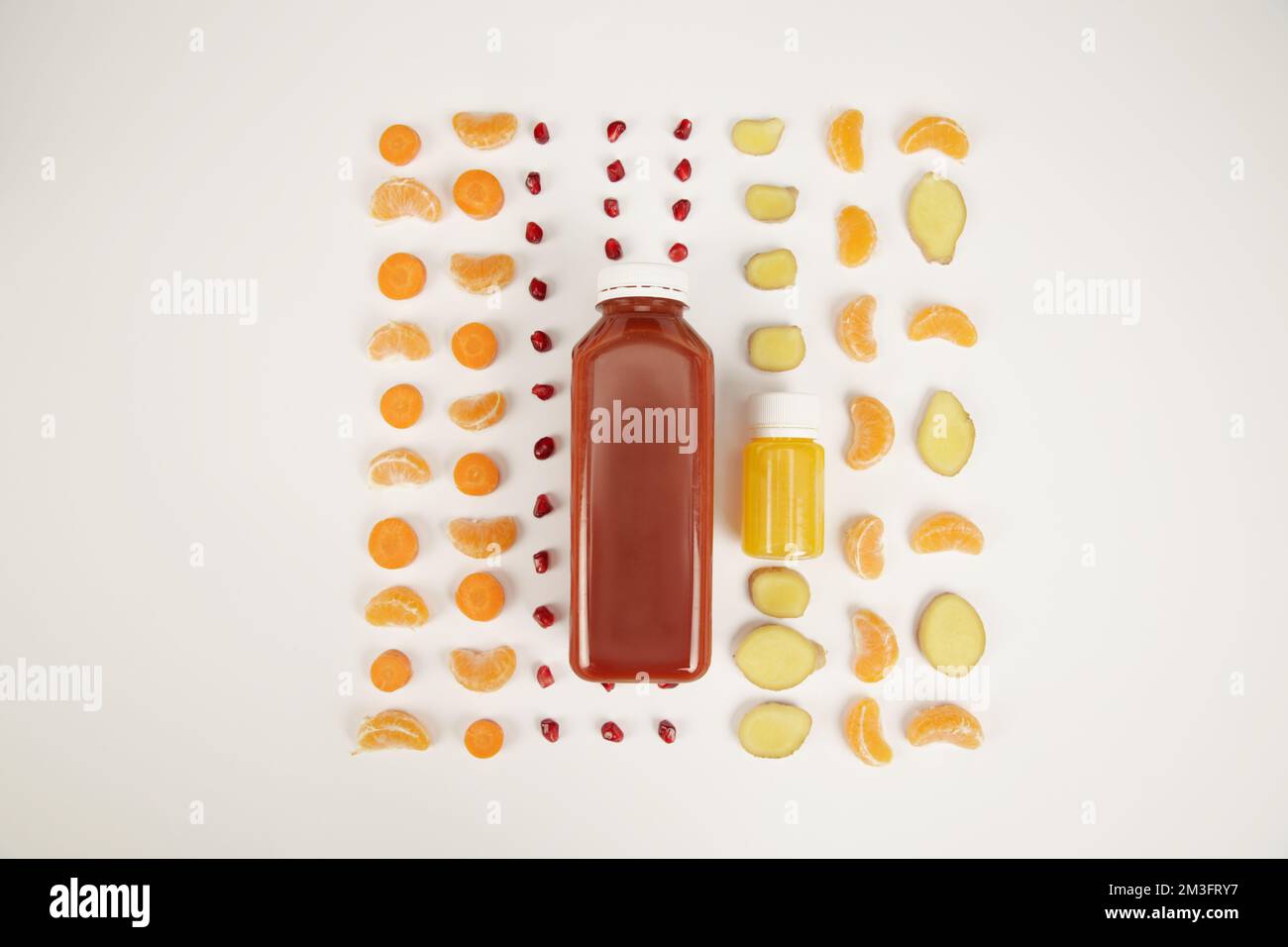 fruit slices and juice in bottle on white background Stock Photo - Alamy