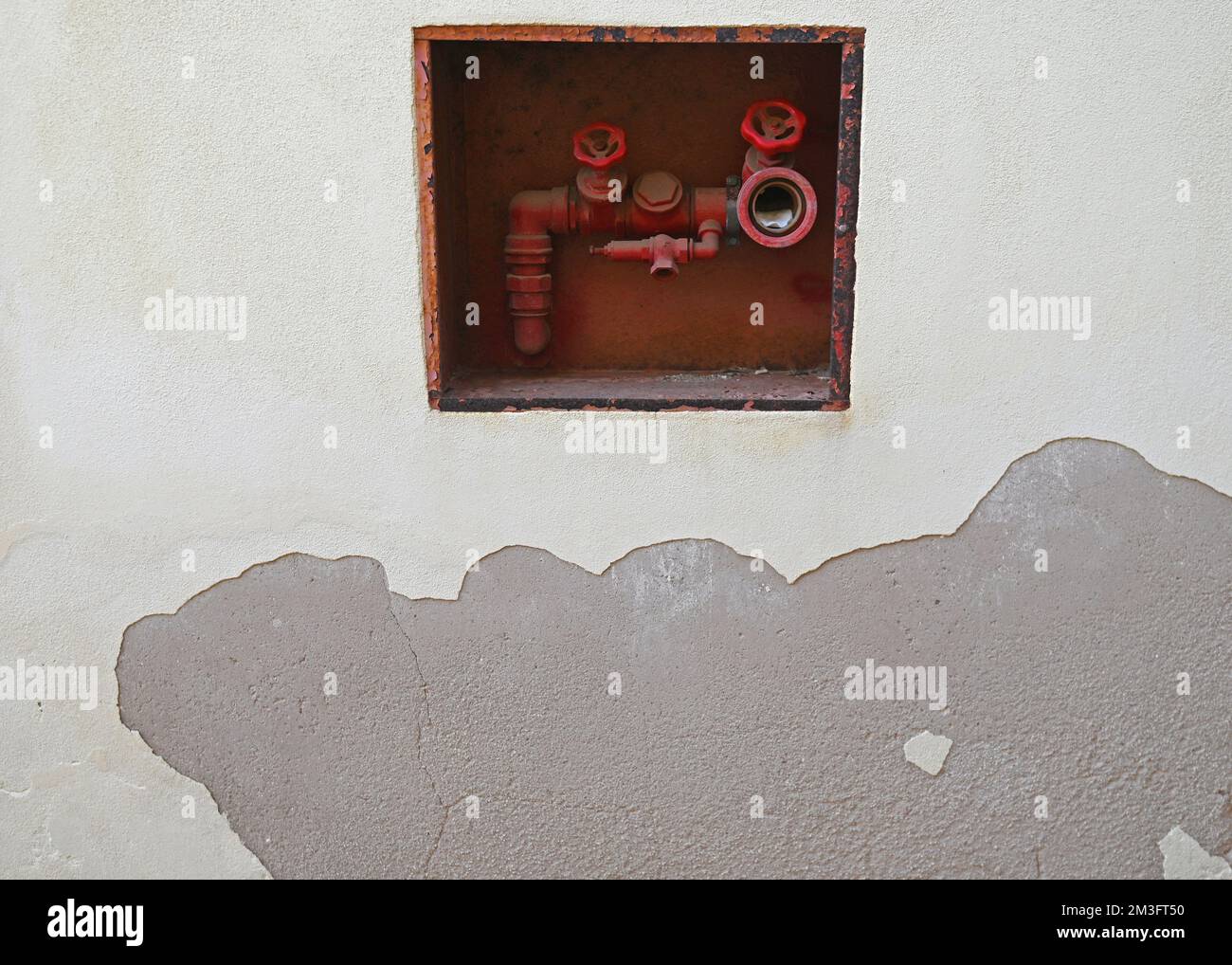 Red fire hose connection at house Castelsardo Sardinia Stock Photo - Alamy