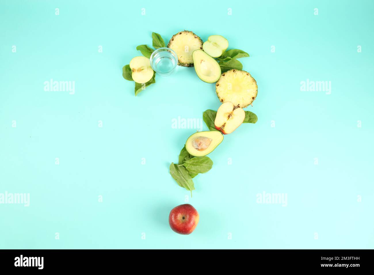 fruit slices with question mark on blue background Stock Photo - Alamy