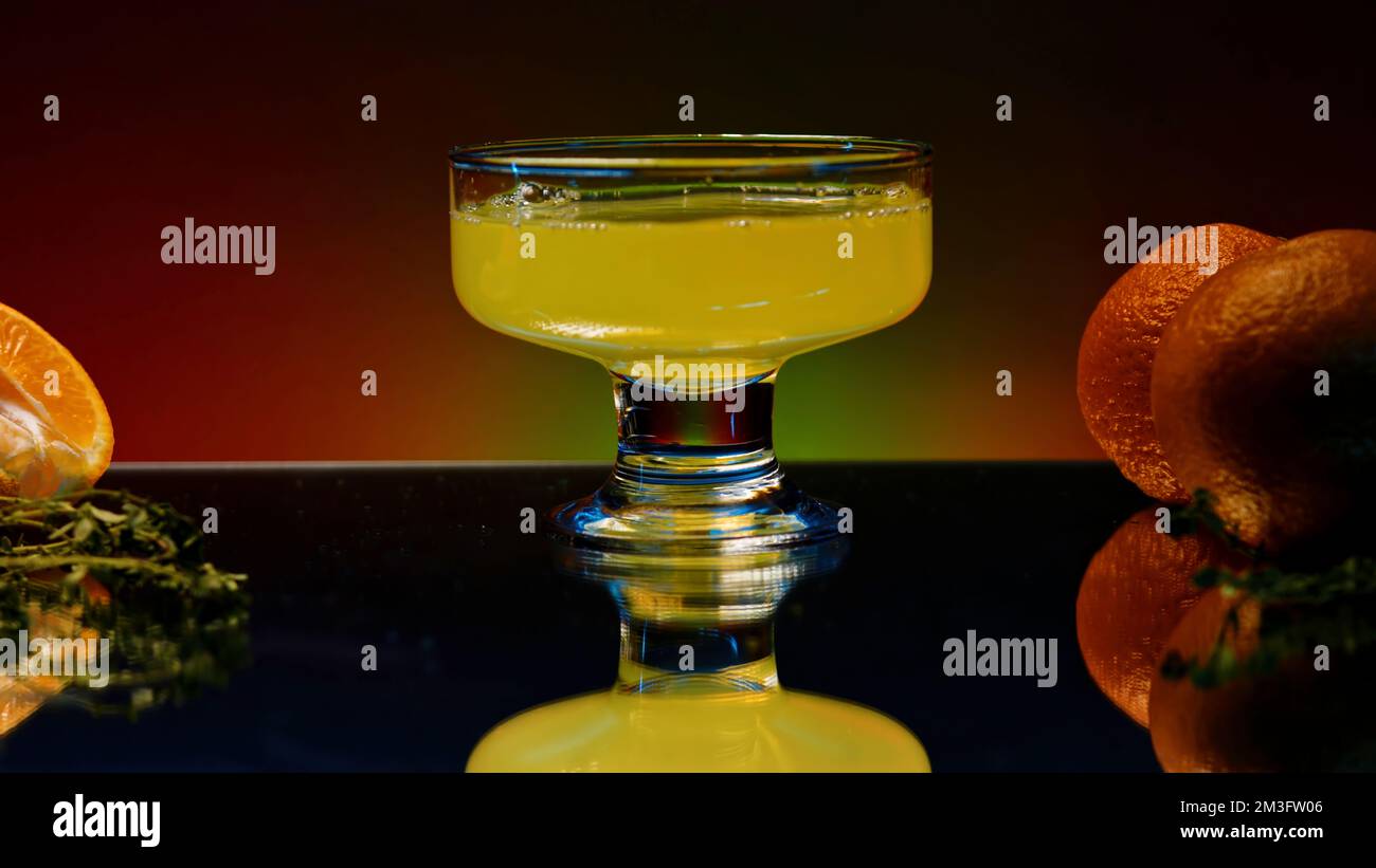 Close up of orange citrus sparkling beverage in the cocktail glass in ...