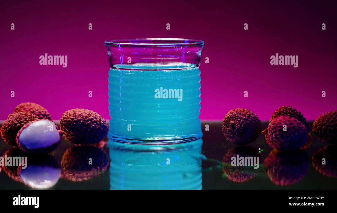 Refreshing non alcoholic beverage of blue color isolated on pink ...