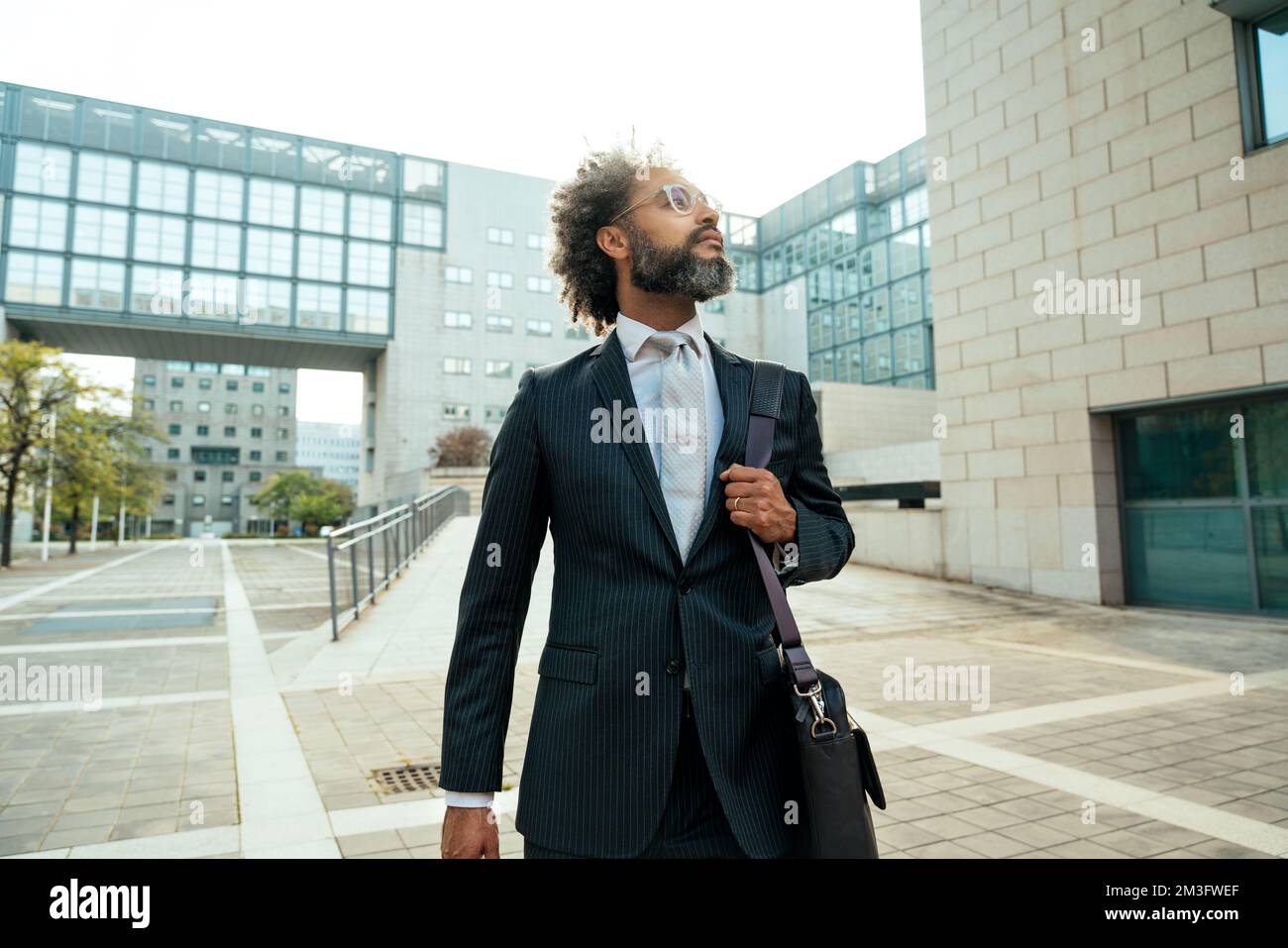 Young entrepreneur business man walking outside his office after a busy ...