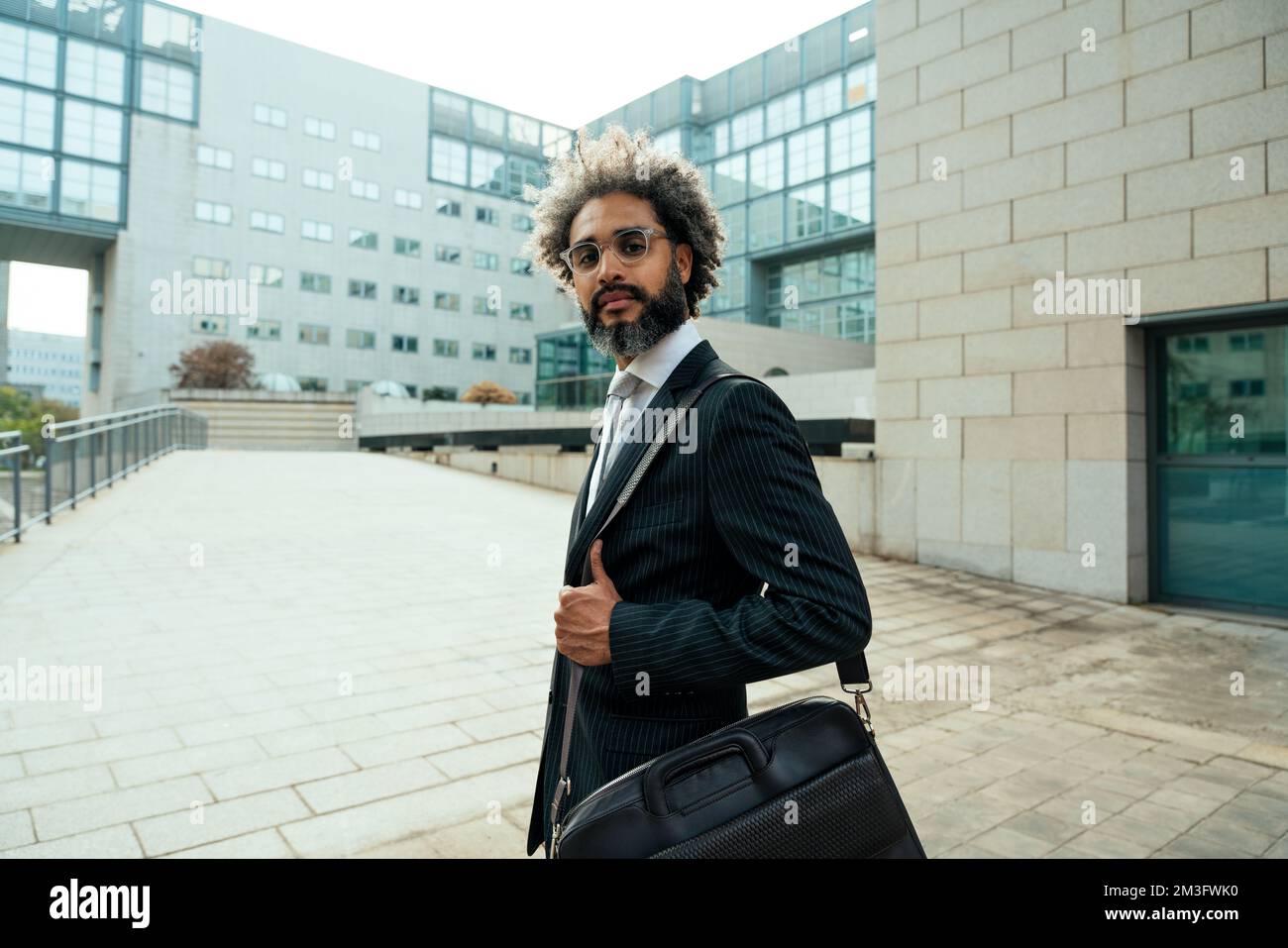 Young entrepreneur business man walking outside his office after a busy ...