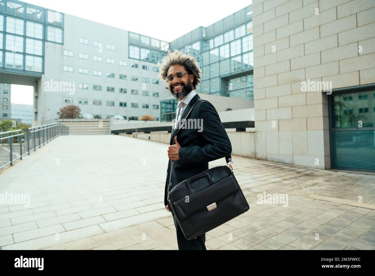 Young entrepreneur business man walking outside his office after a busy ...