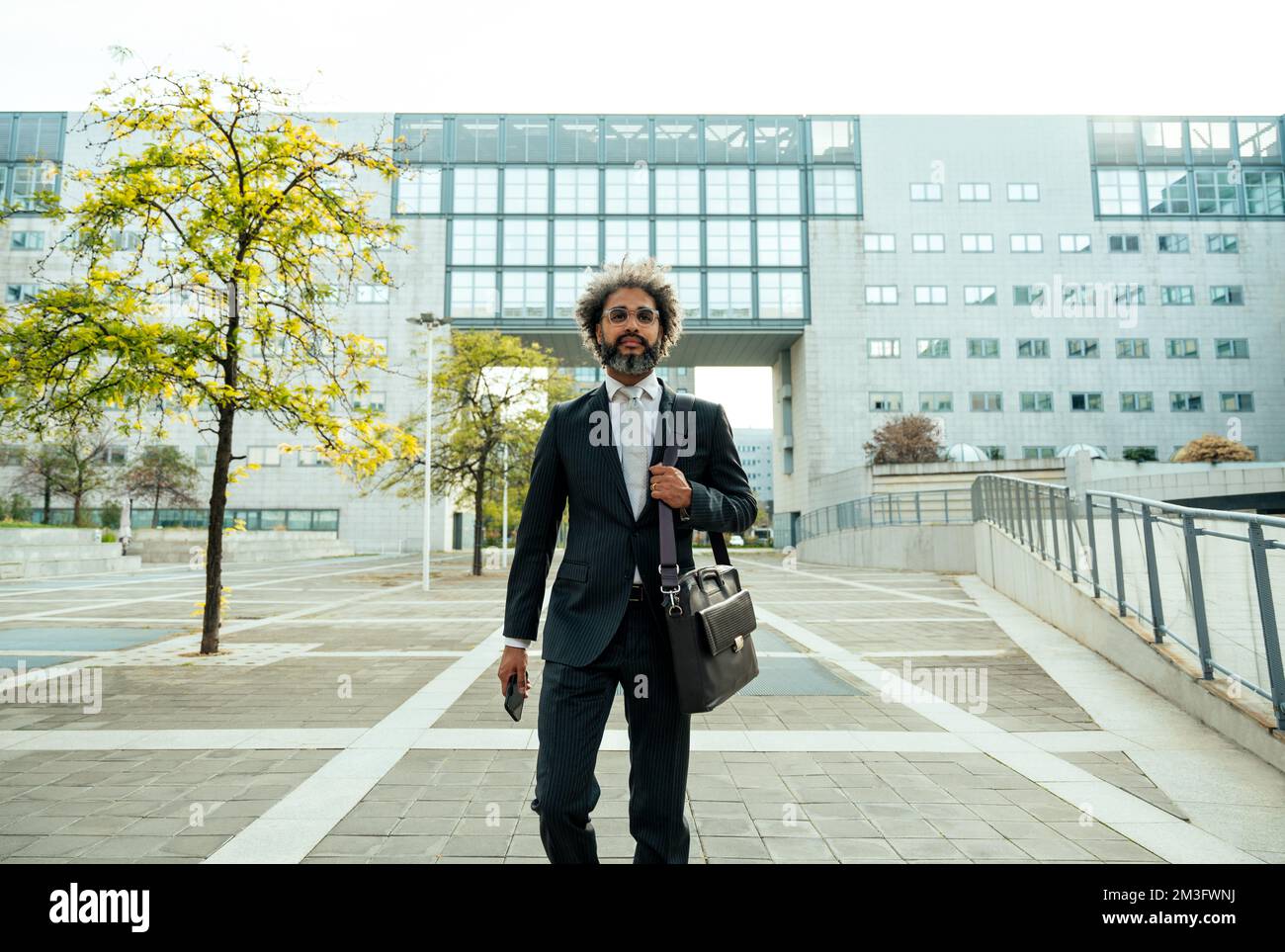 Young entrepreneur business man walking outside his office after a busy ...