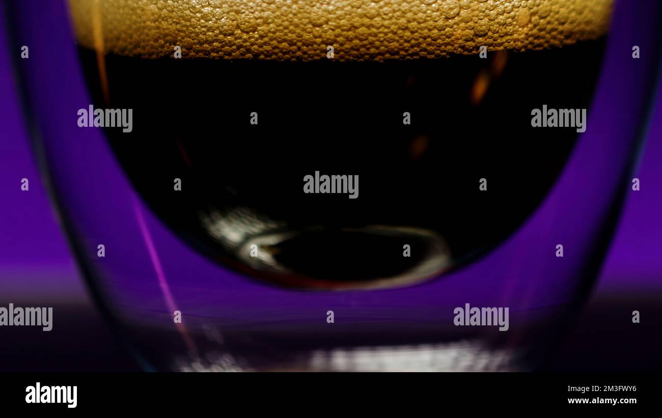 Soda bubbles in a glass against a dark wall changing colors. Stock clip ...
