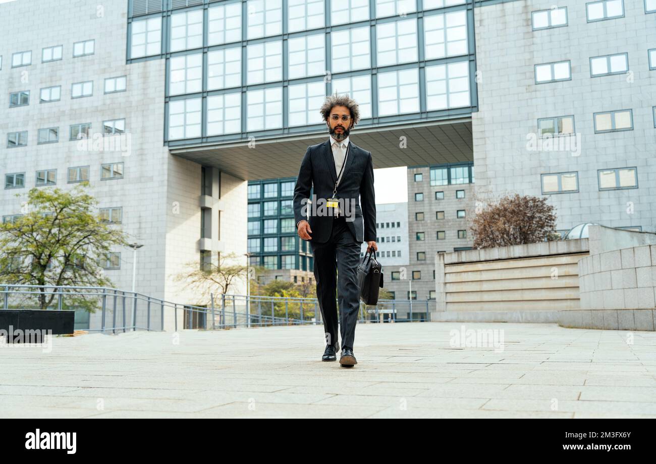Young entrepreneur business man walking outside his office after a busy ...