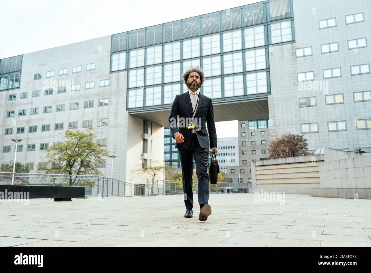 Young entrepreneur business man walking outside his office after a busy ...