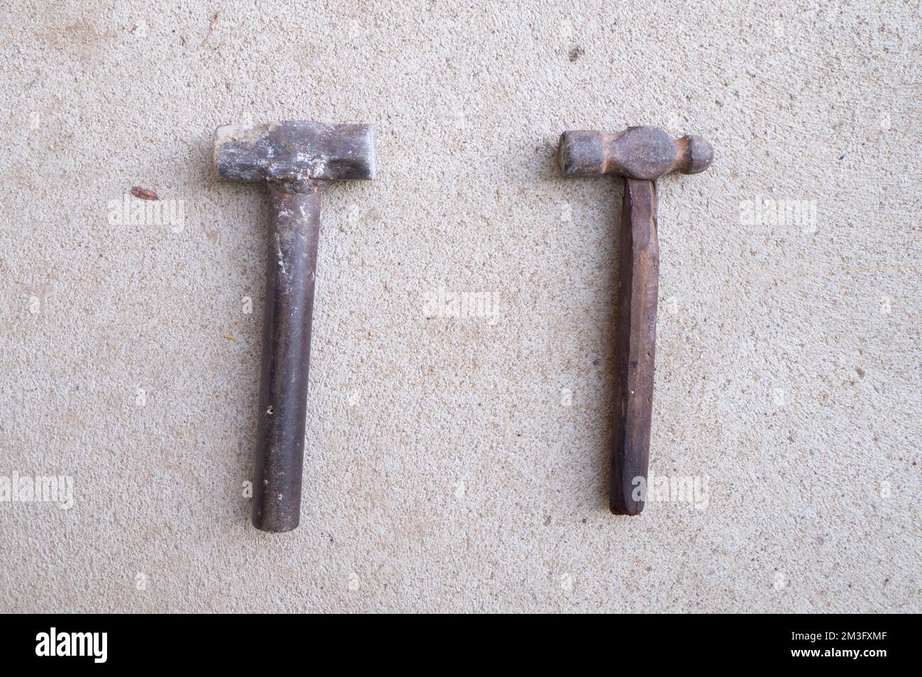 Old round metal hammer on the cement floor Stock Photo - Alamy