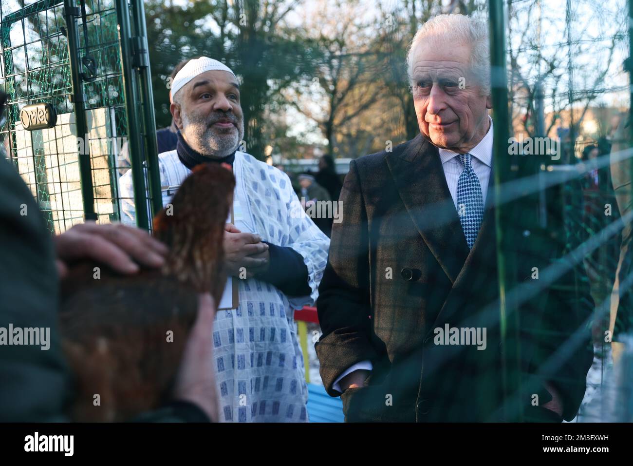 King Charles III looks at a chicken during a visit to London's ...
