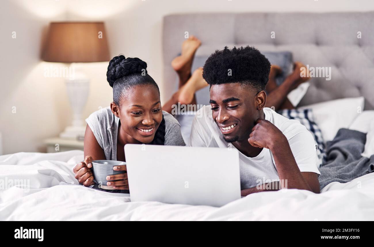 What will we be streaming today. a young couple using a laptop while ...