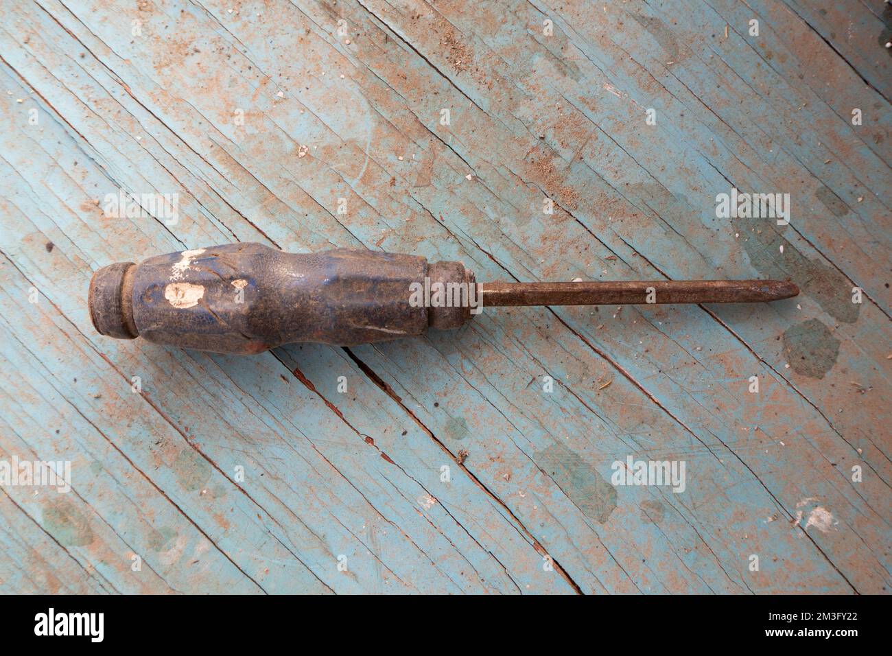 Screwdriver old blue wood background Stock Photo - Alamy