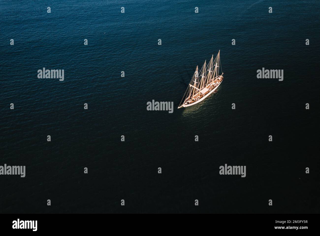 An aerial view of a white ship without sails in the blue sea Stock ...