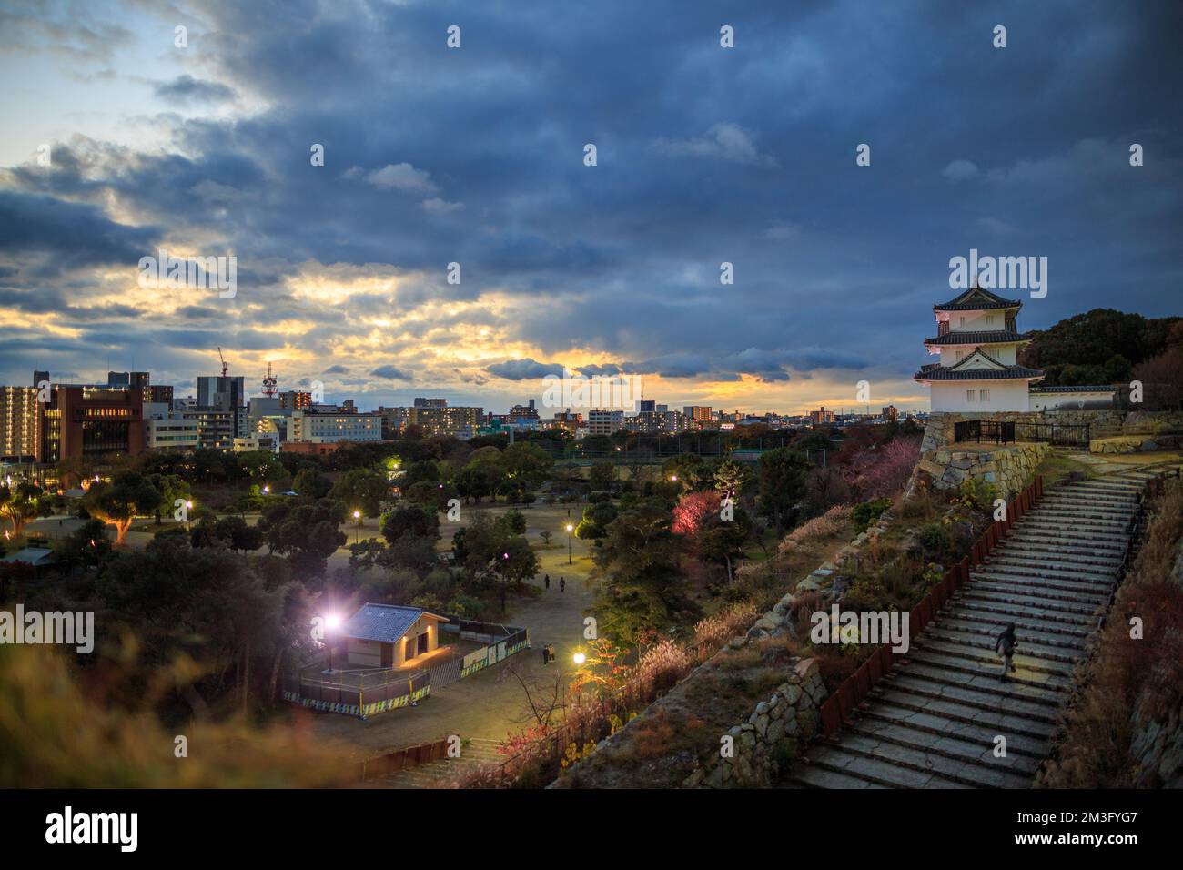 Dramatic sunset breaks through clouds over historic Japanese Castle ...