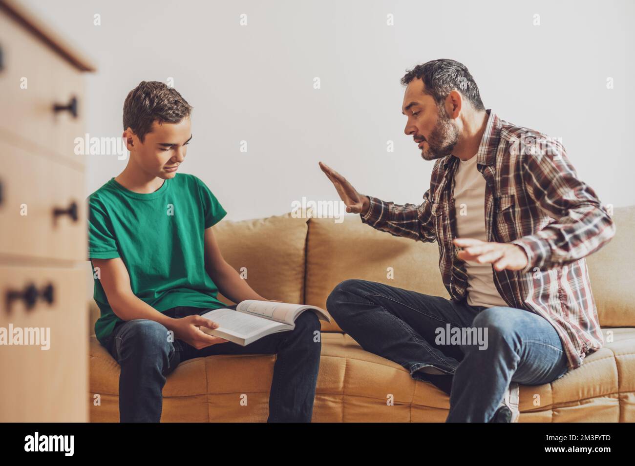 Father is helping his son with learning. Boy is having problem with ...