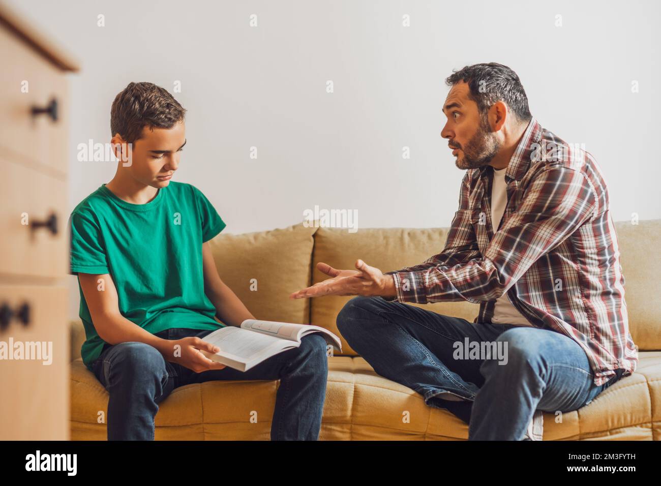 Father is helping his son with learning. Boy is having problem with ...