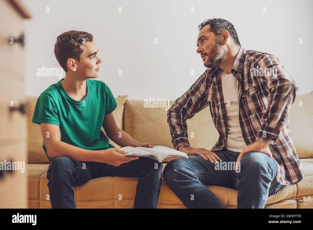 Father is helping his son with learning. Boy is having problem with ...