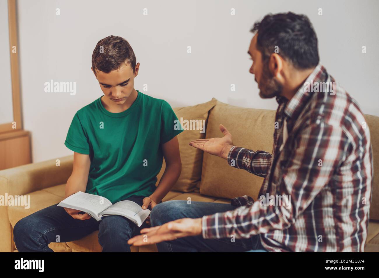 Father is helping his son with learning. Boy is having problem with ...