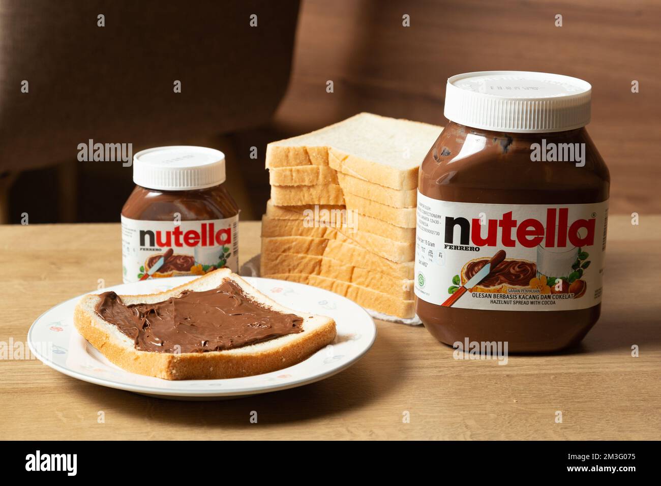 Nutella with large and small bottles and some white bread neatly ...