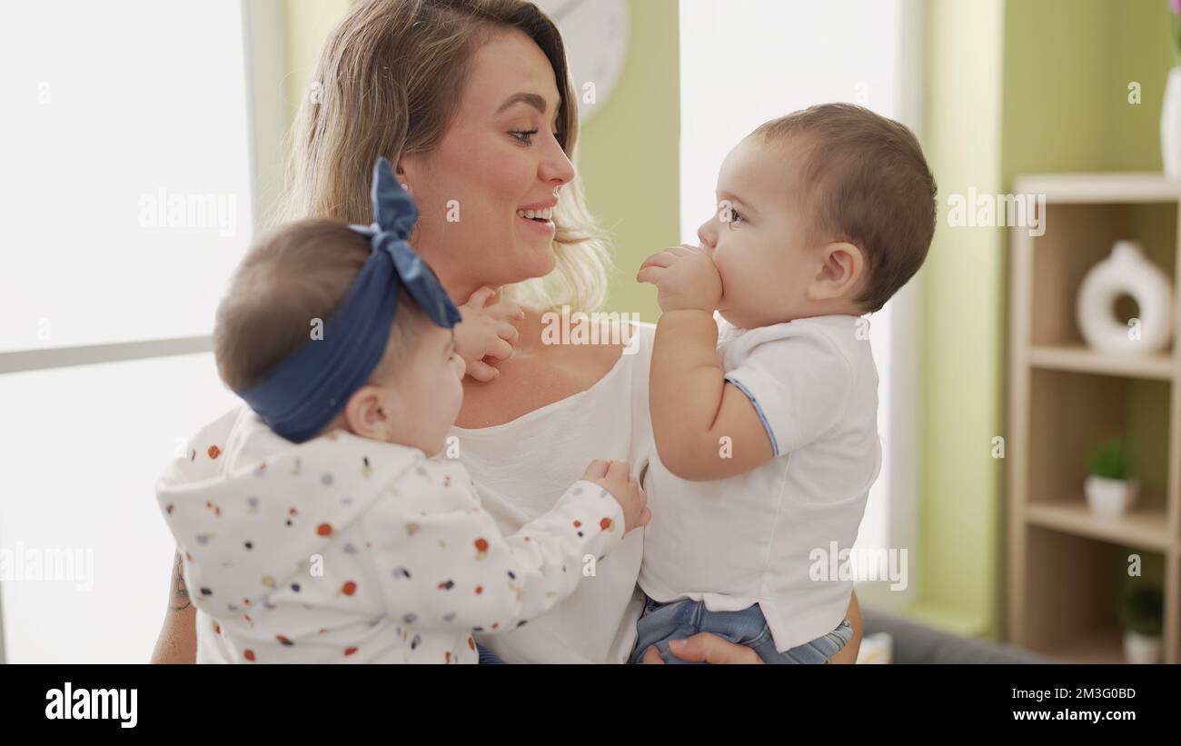 Mother and toddlers smiling confident standing at home Stock Photo - Alamy